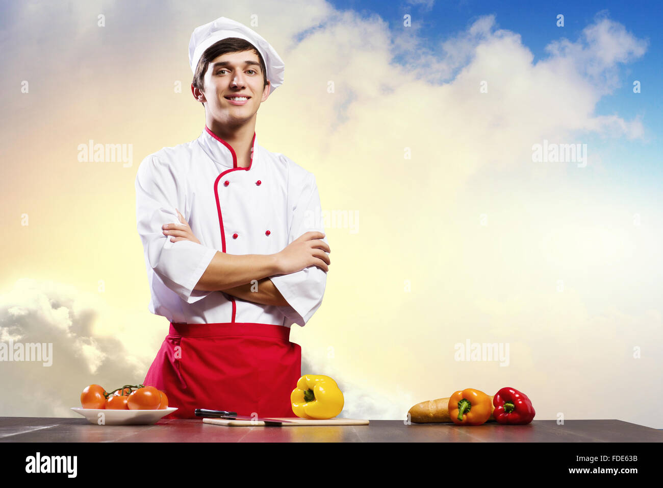 Young cheerful cook and ingredients flying in air Stock Photo - Alamy