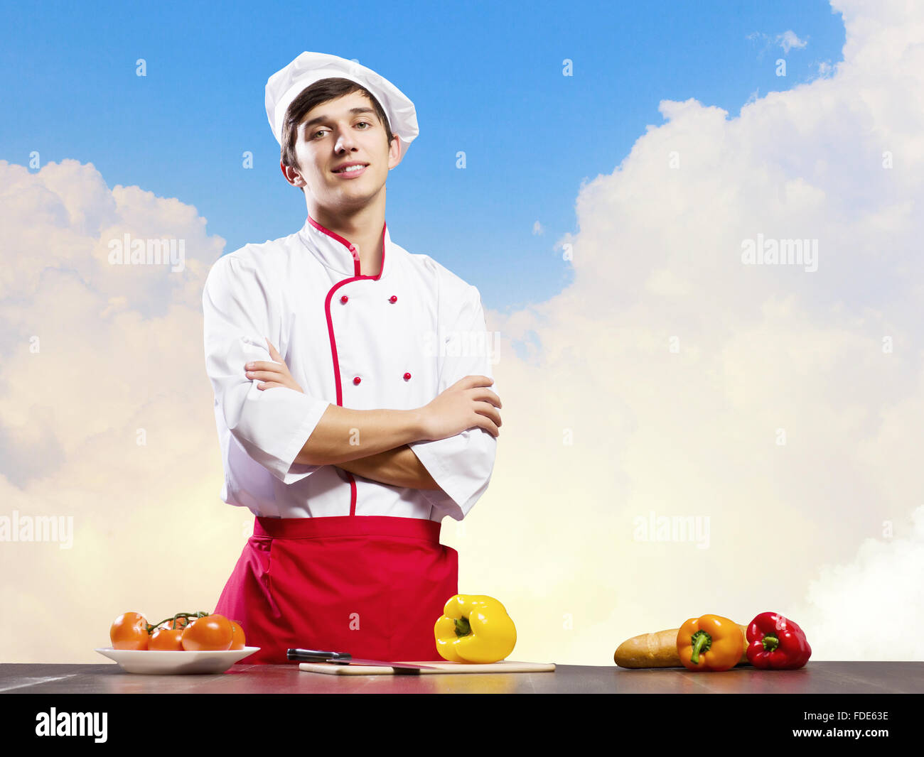 Young cheerful cook and ingredients flying in air Stock Photo - Alamy