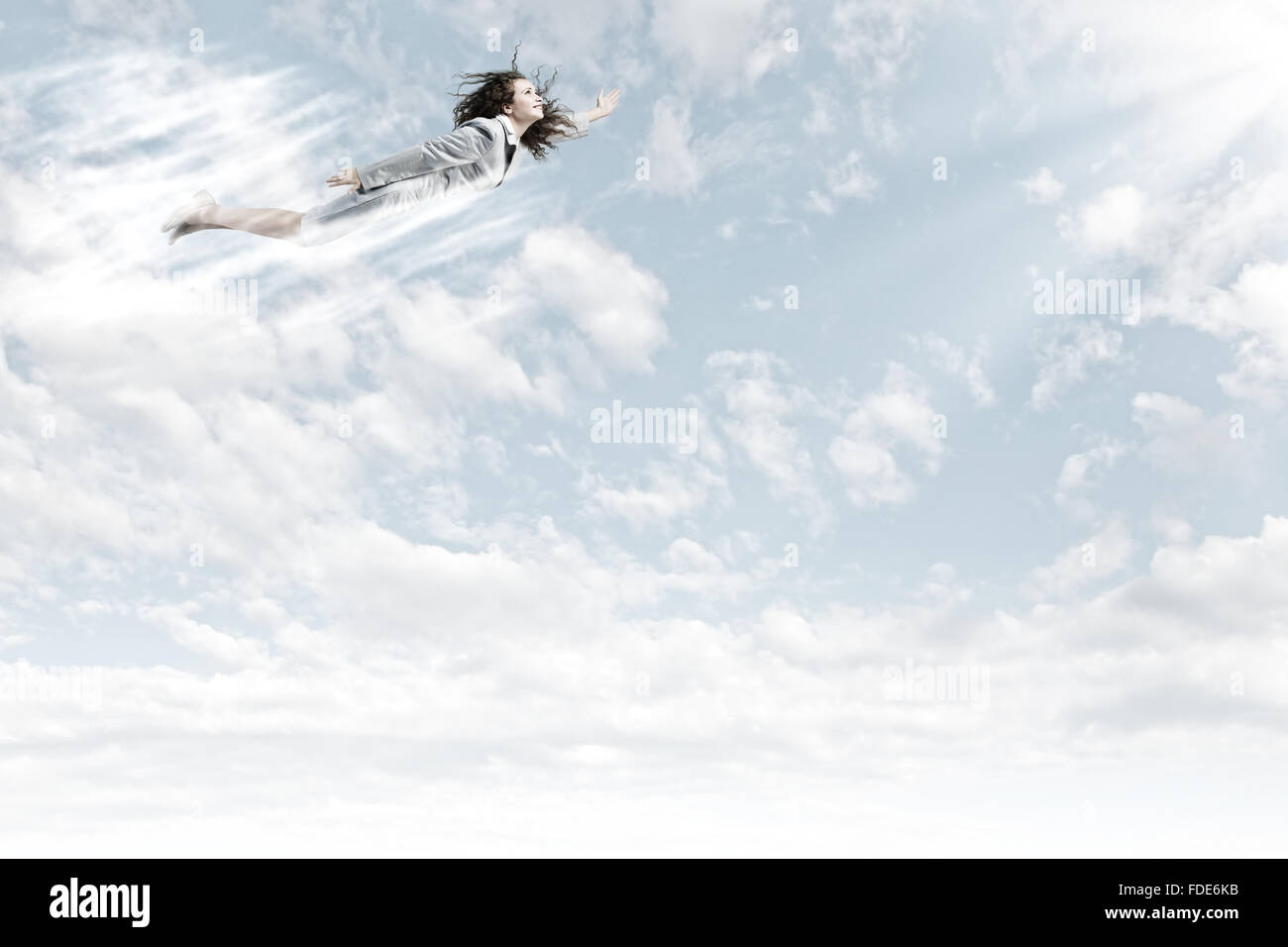 Young determined businesswoman flying high in sky Stock Photo - Alamy
