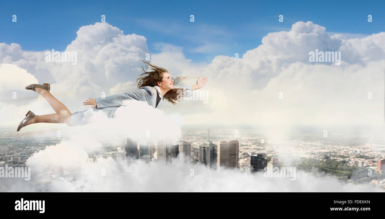 Young determined businesswoman flying high in sky Stock Photo - Alamy