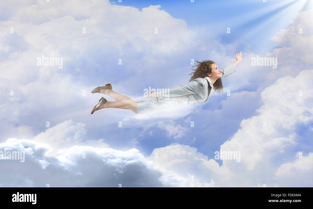 Young determined businesswoman flying high in sky Stock Photo - Alamy
