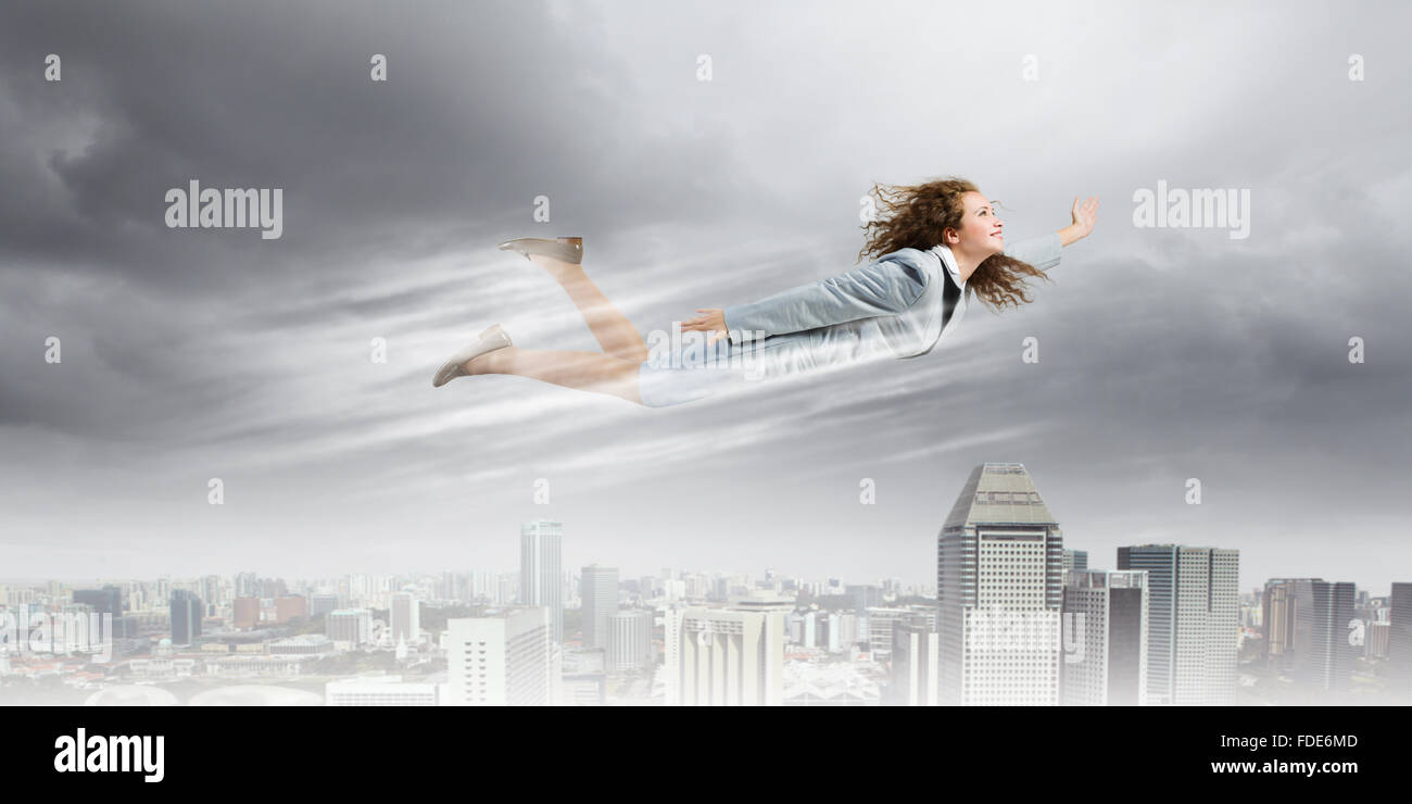 Young determined businesswoman flying high in sky Stock Photo - Alamy
