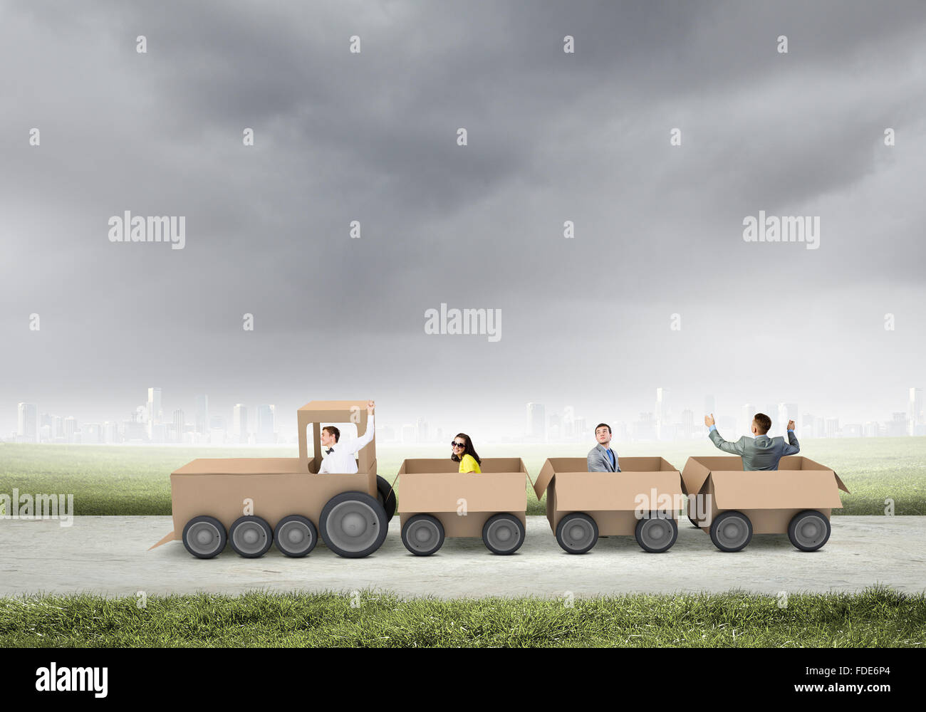 Young business people riding carton train. Teamwork concept Stock Photo ...