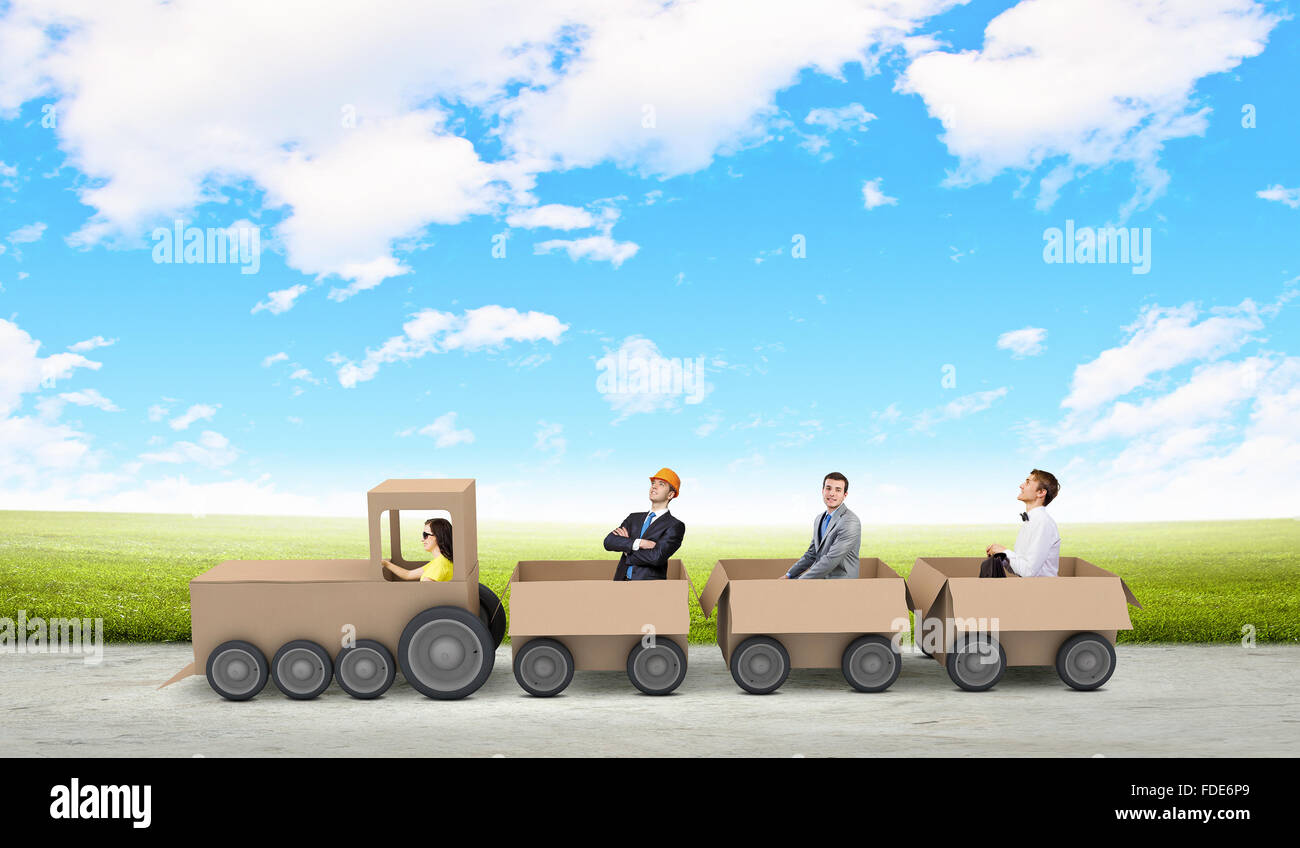 Young business people riding carton train. Teamwork concept Stock Photo ...