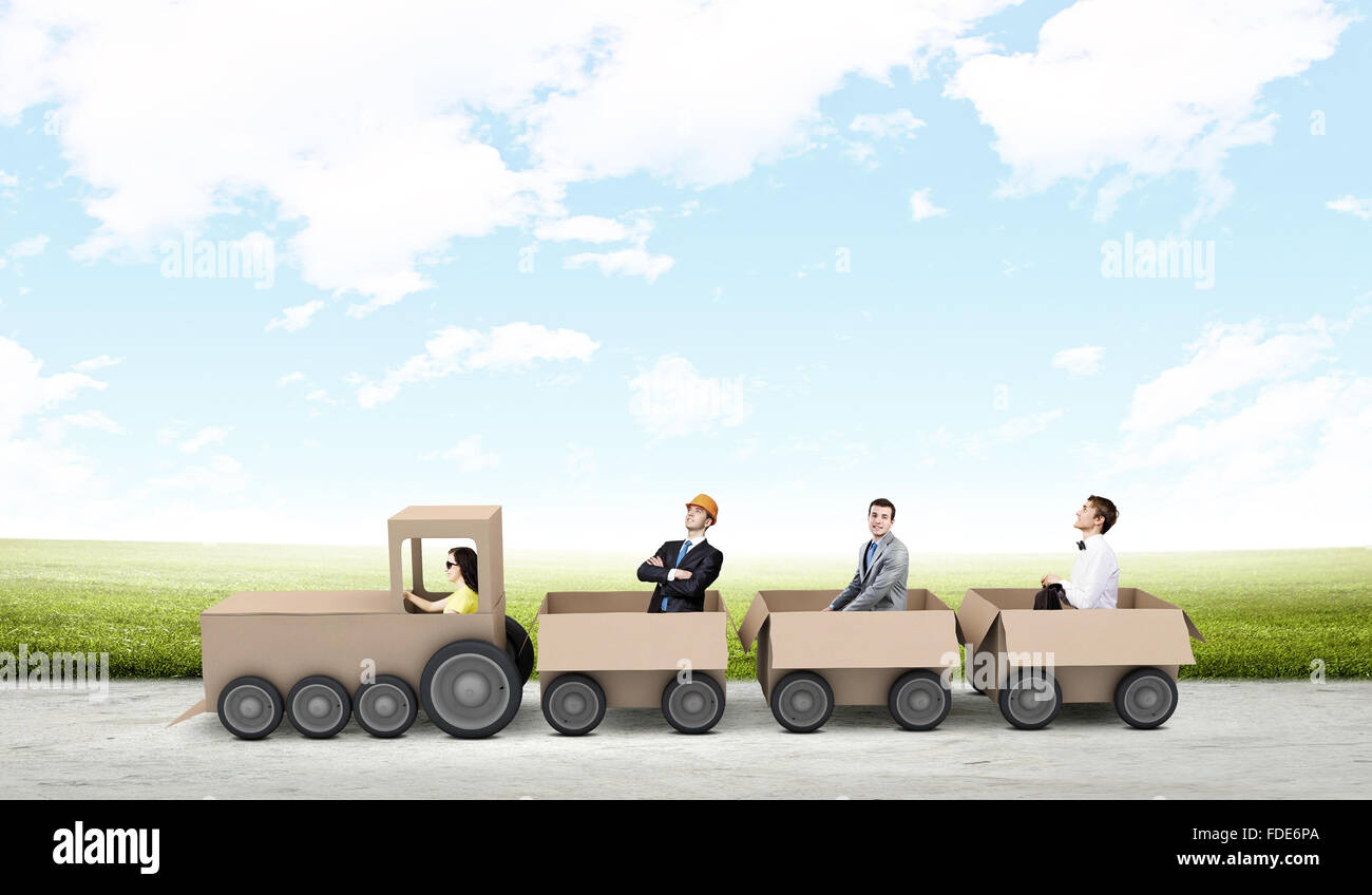 Young business people riding carton train. Teamwork concept Stock Photo ...