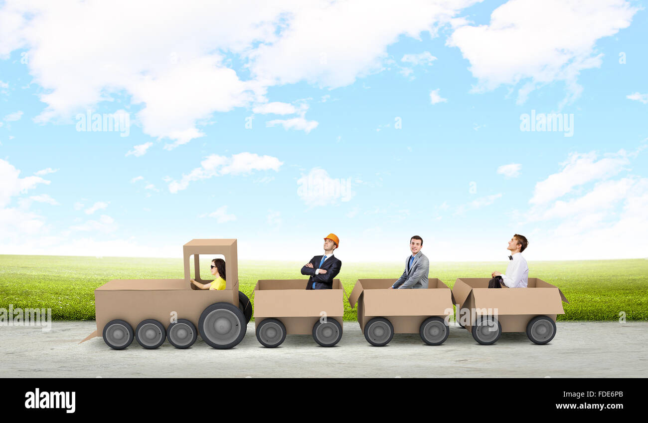 Young business people riding carton train. Teamwork concept Stock Photo ...
