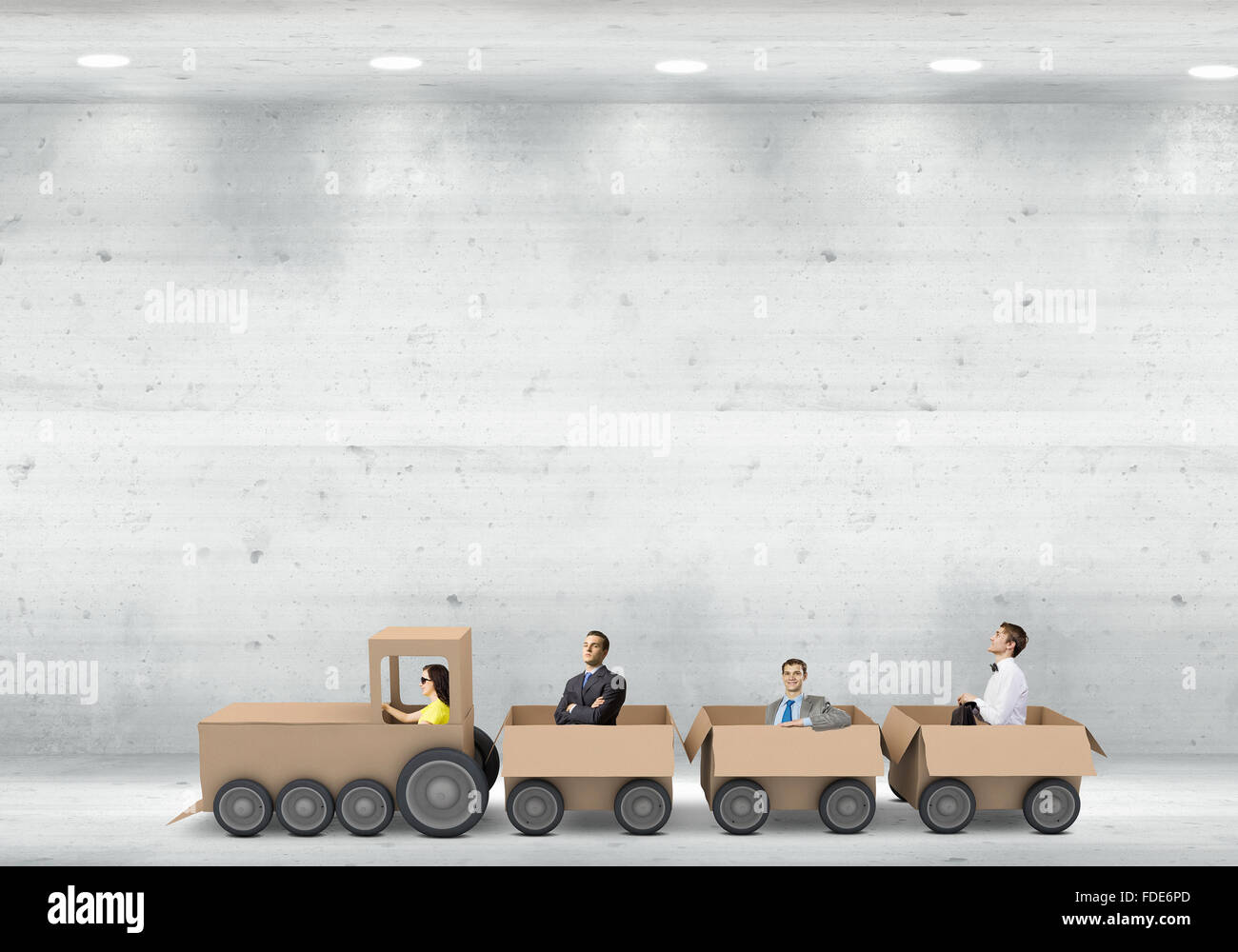 Young business people riding carton train. Teamwork concept Stock Photo ...