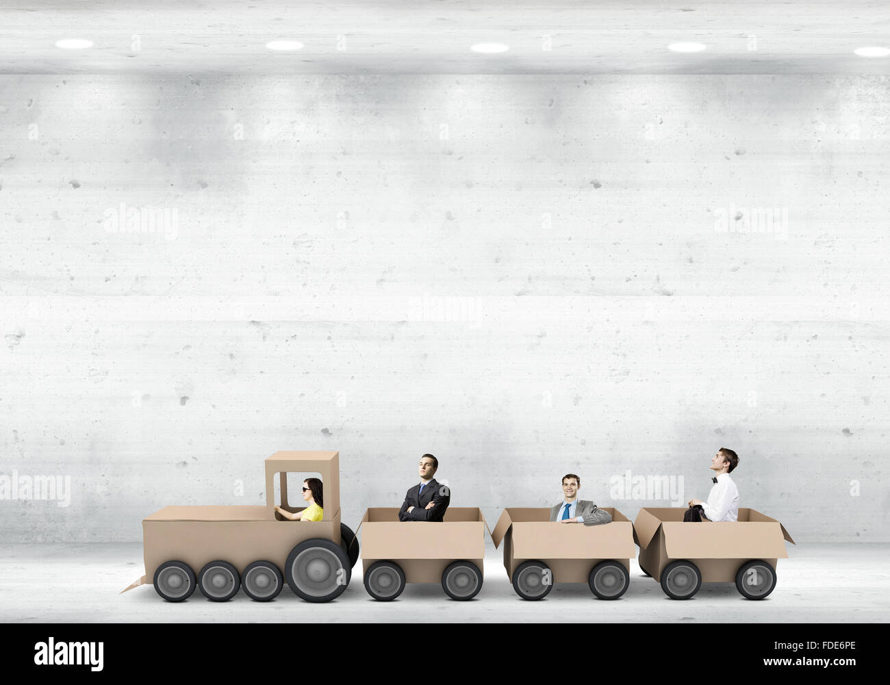 Young business people riding carton train. Teamwork concept Stock Photo ...