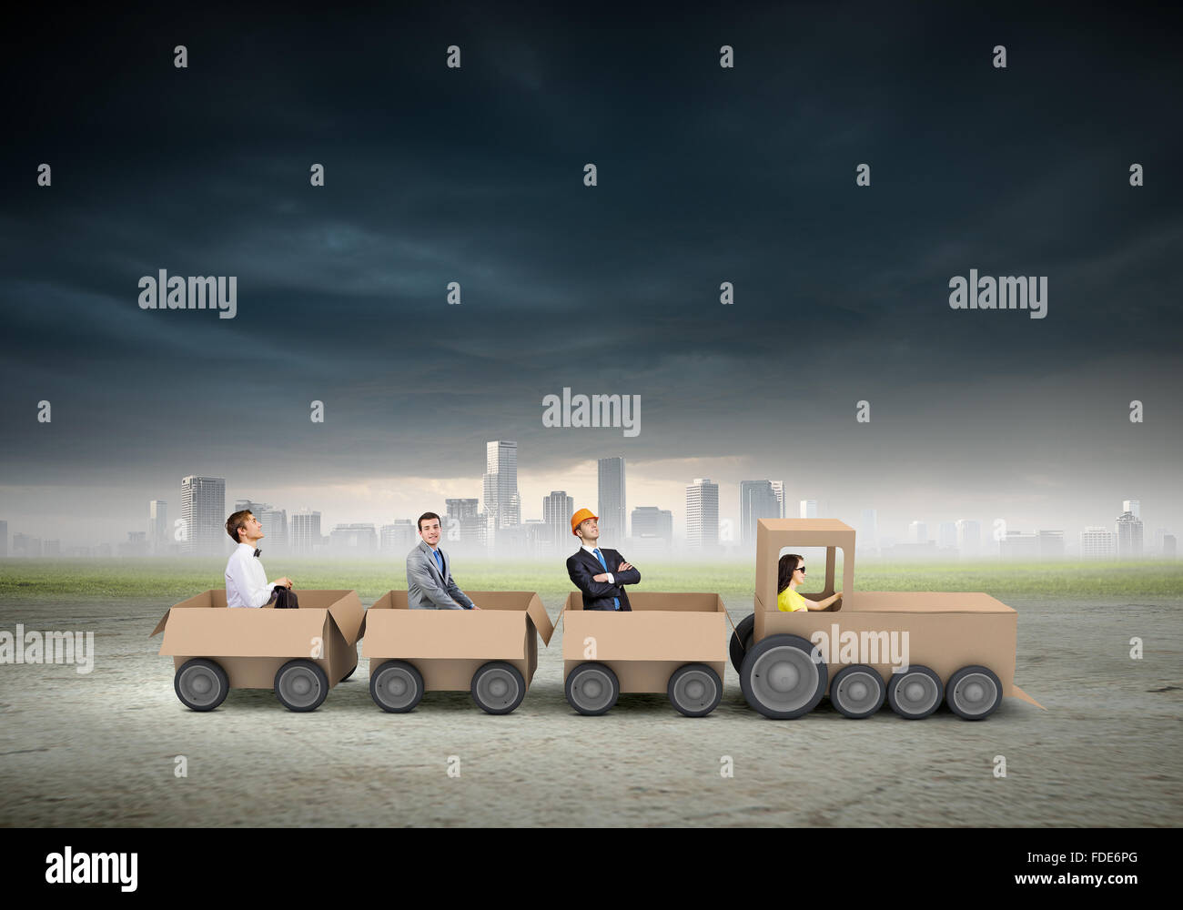 Young business people riding carton train. Teamwork concept Stock Photo ...
