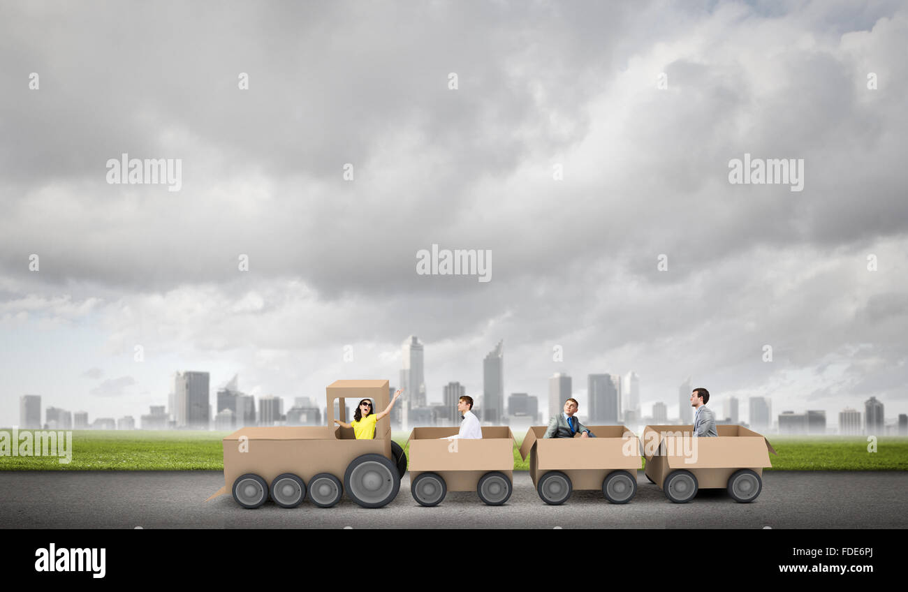 Young business people riding carton train. Teamwork concept Stock Photo ...