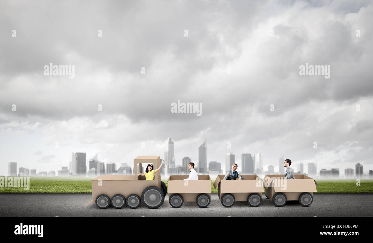 Young business people riding carton train. Teamwork concept Stock Photo ...