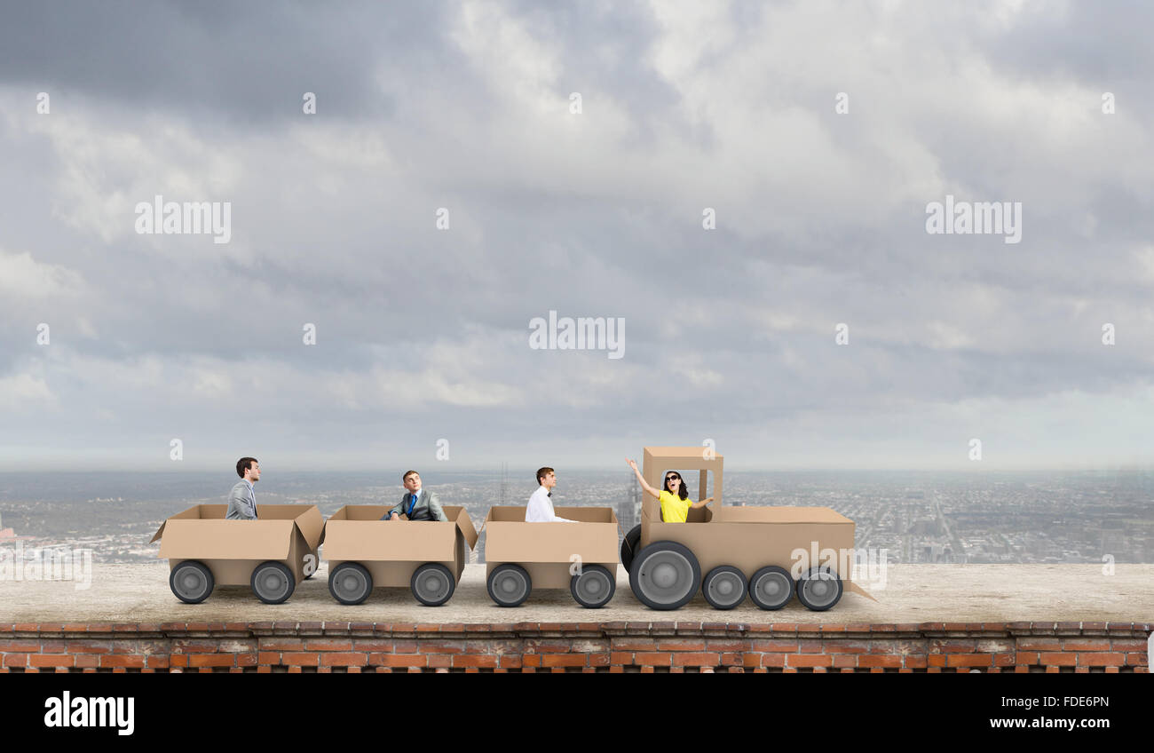 Young business people riding carton train. Teamwork concept Stock Photo ...