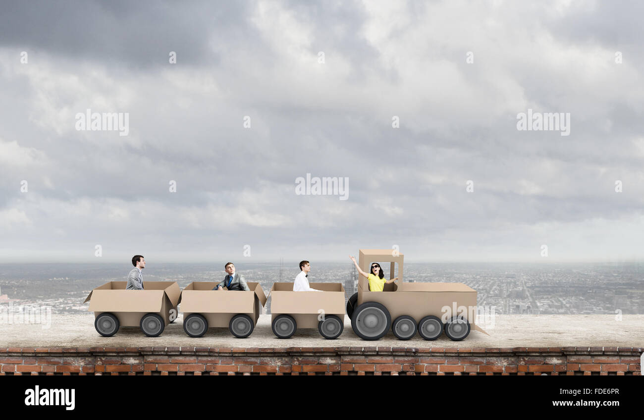 Young business people riding carton train. Teamwork concept Stock Photo ...
