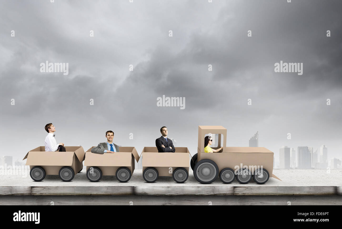 Young business people riding carton train. Teamwork concept Stock Photo ...