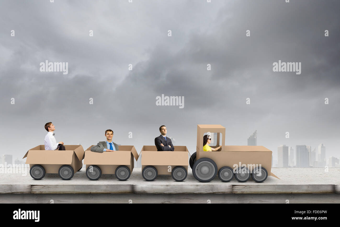 Young business people riding carton train. Teamwork concept Stock Photo ...