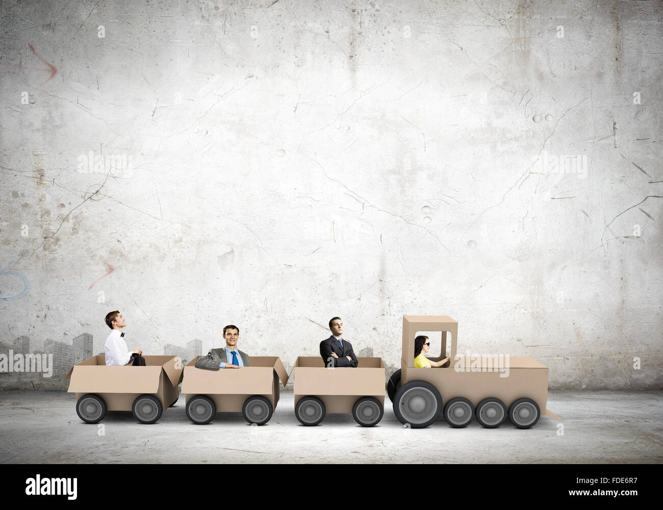 Young business people riding carton train. Teamwork concept Stock Photo ...