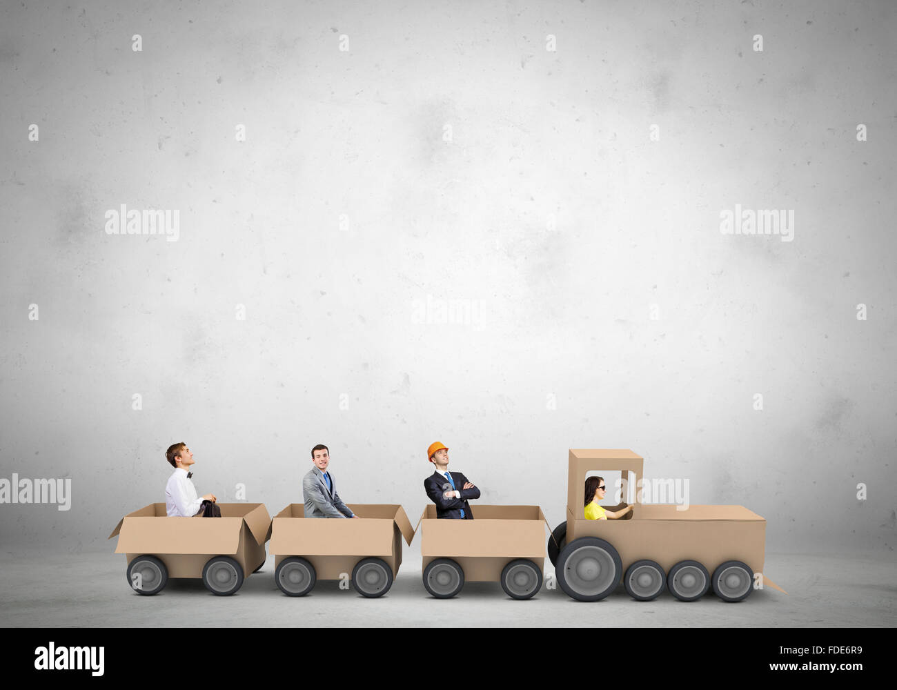 Young business people riding carton train. Teamwork concept Stock Photo ...