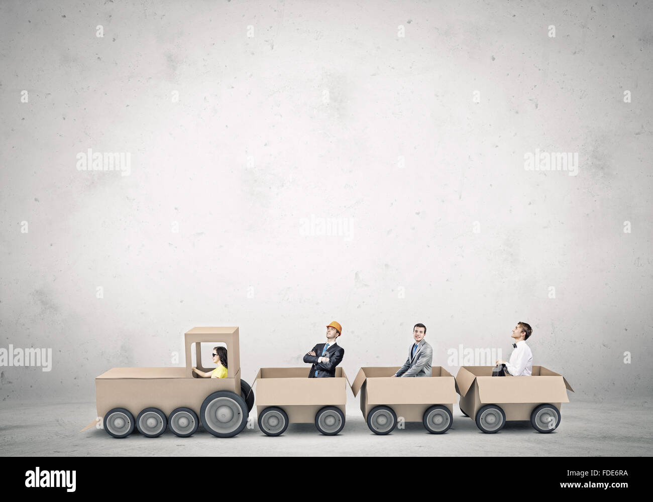 Young business people riding carton train. Teamwork concept Stock Photo ...