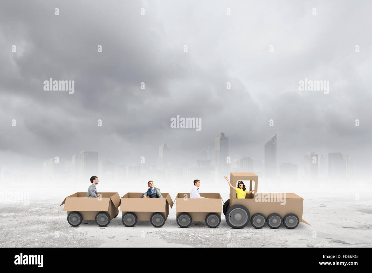 Young business people riding carton train. Teamwork concept Stock Photo ...