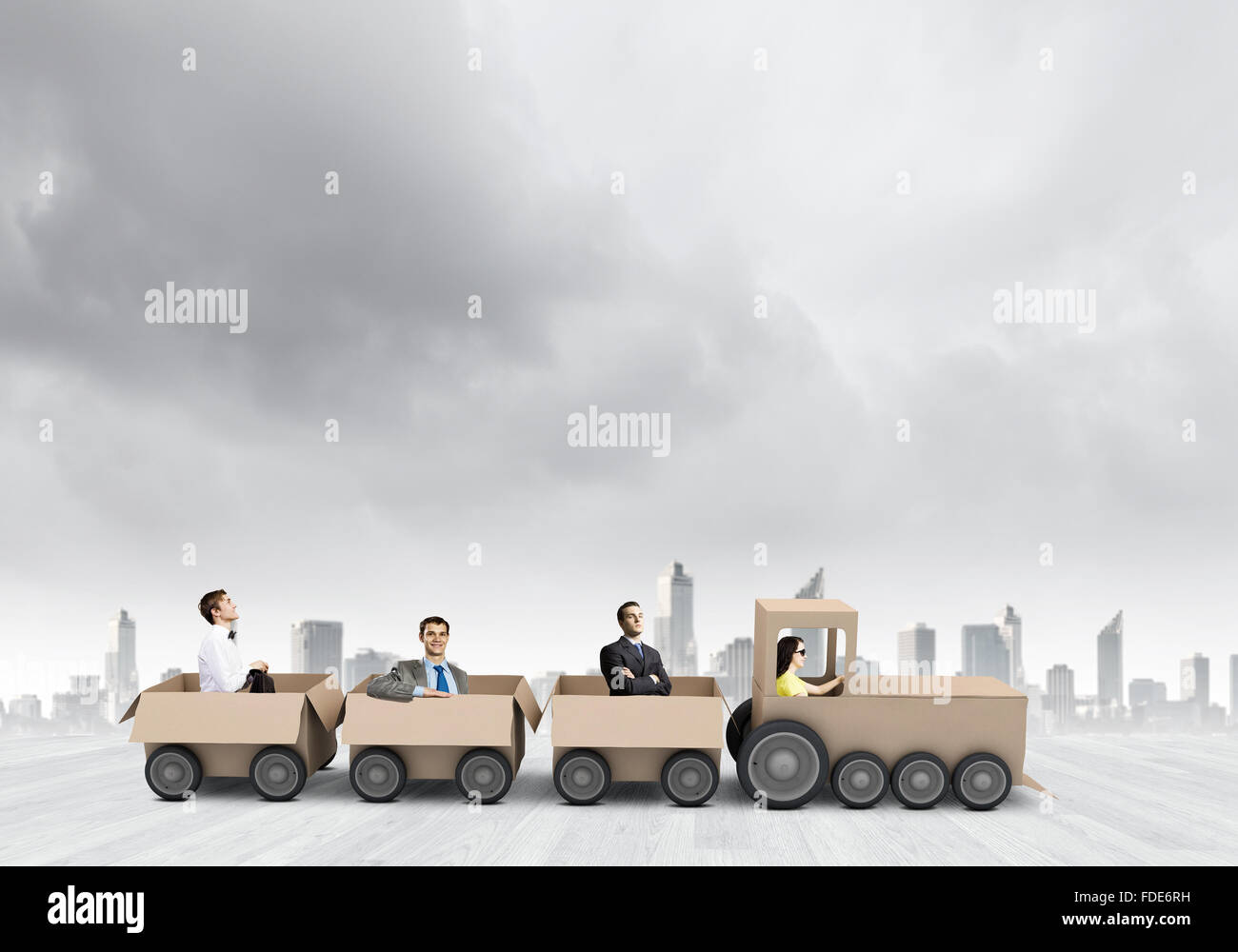 Young business people riding carton train. Teamwork concept Stock Photo ...