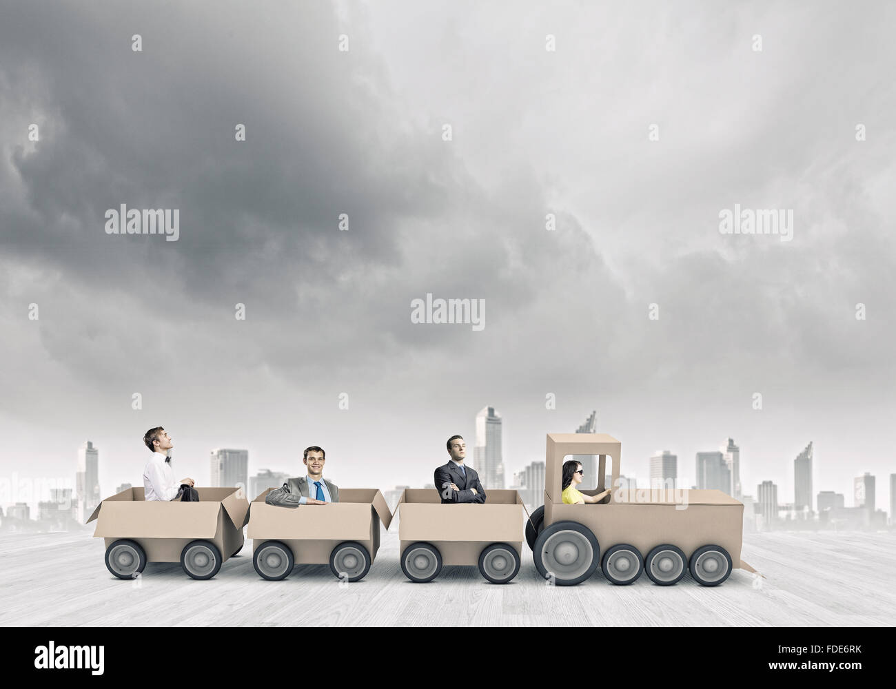 Young business people riding carton train. Teamwork concept Stock Photo ...