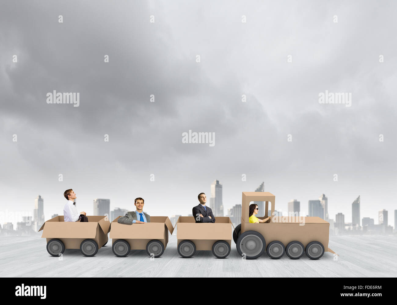 Young business people riding carton train. Teamwork concept Stock Photo ...