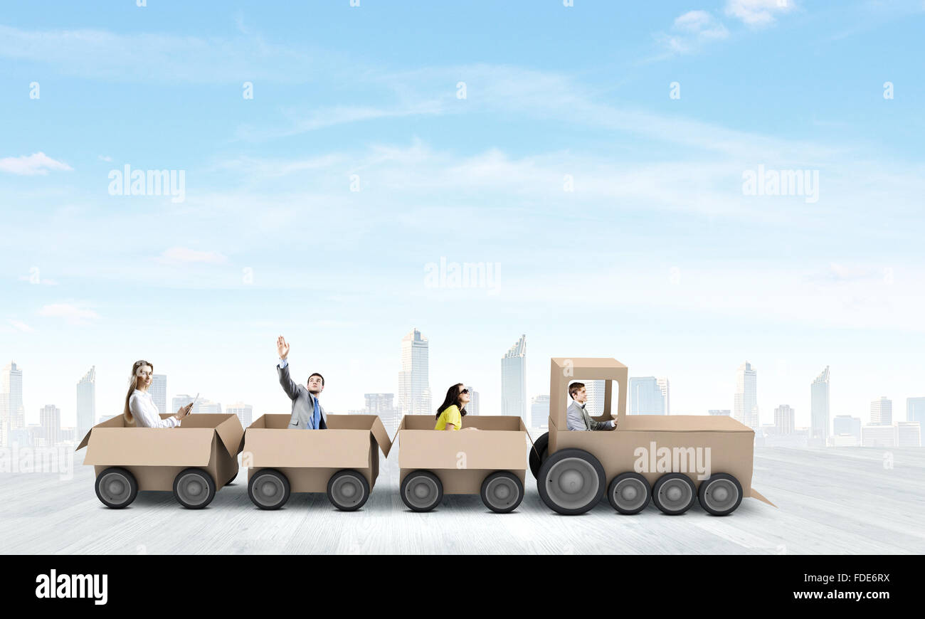 Young business people riding carton train. Teamwork concept Stock Photo ...