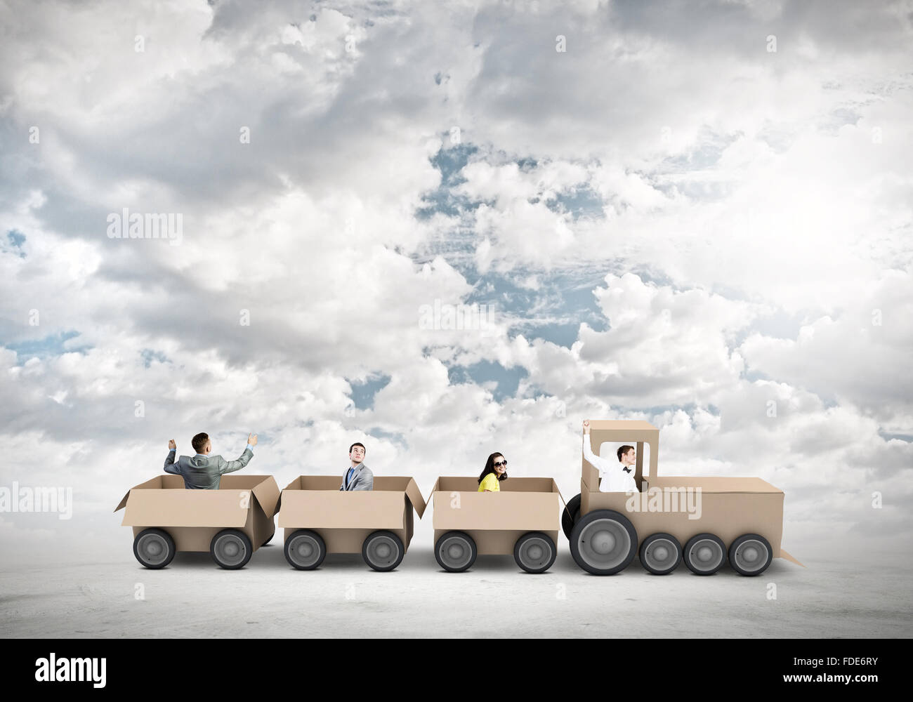 Young business people riding carton train. Teamwork concept Stock Photo ...