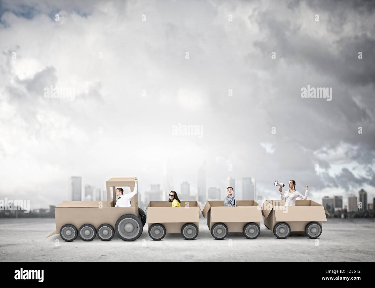 Young business people riding carton train. Teamwork concept Stock Photo ...