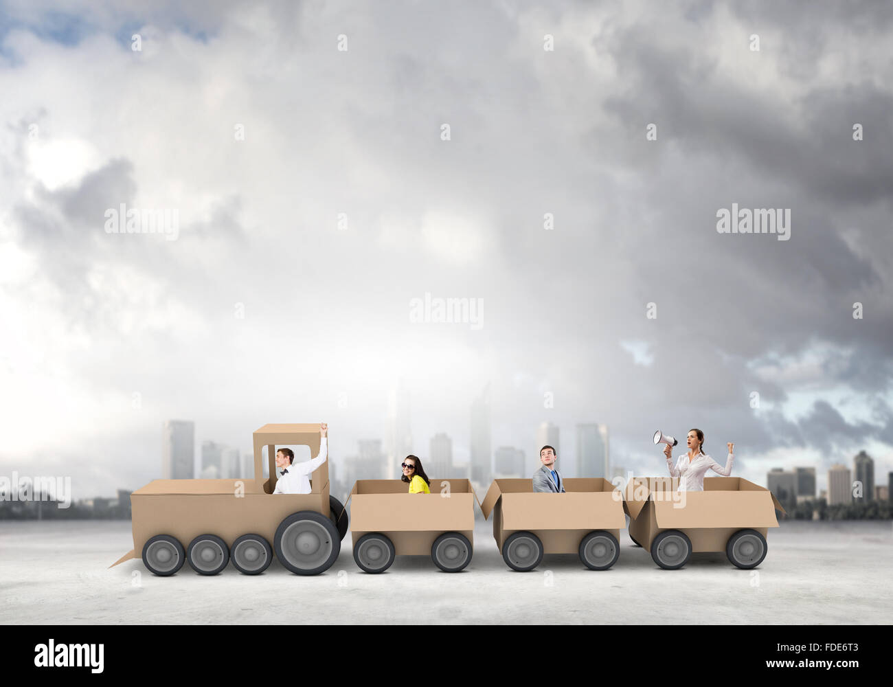 Young business people riding carton train. Teamwork concept Stock Photo ...
