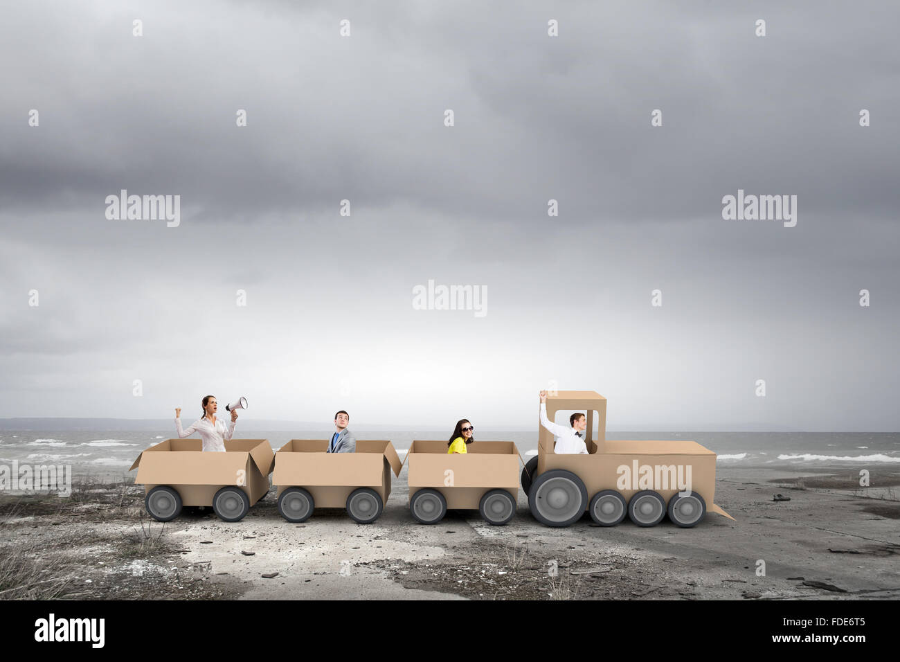 Young business people riding carton train. Teamwork concept Stock Photo ...