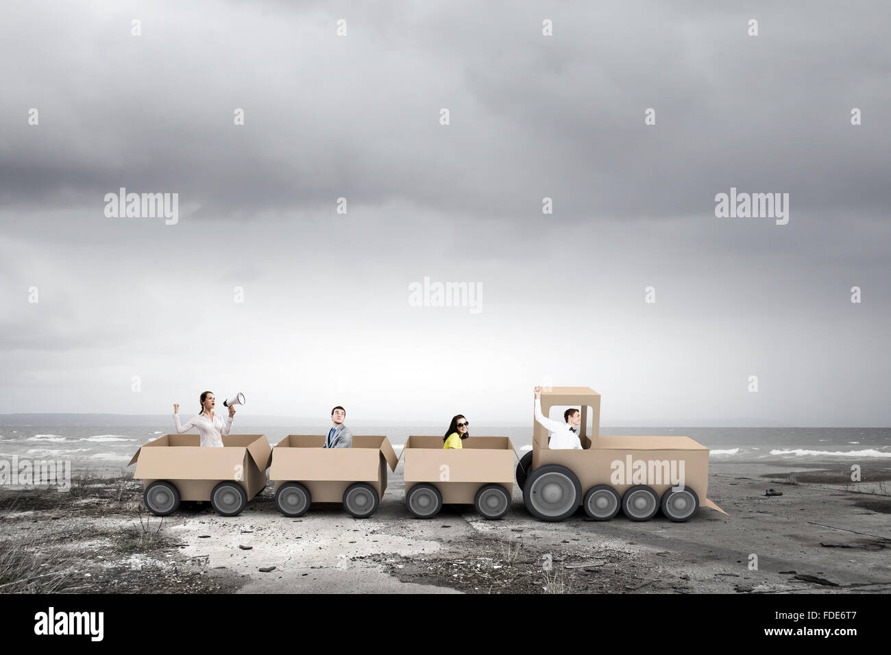 Young business people riding carton train. Teamwork concept Stock Photo ...