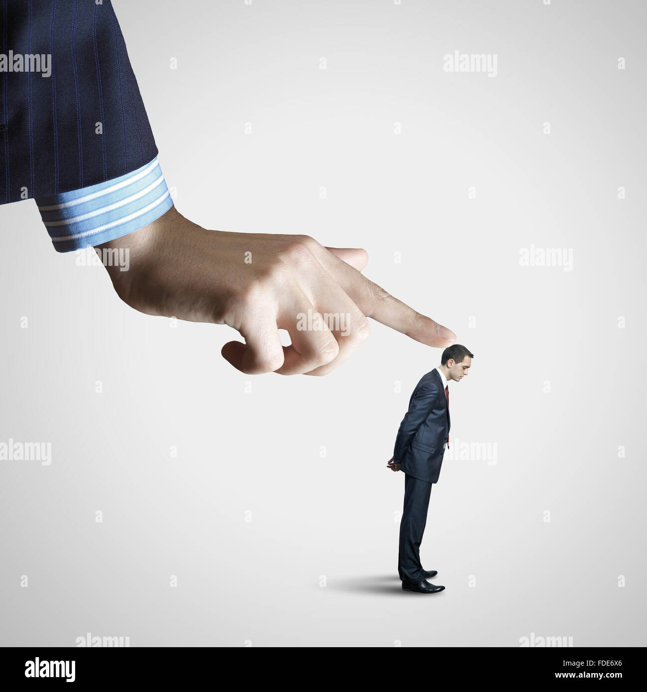 Close up of male businessman pointing at miniature of man Stock Photo ...