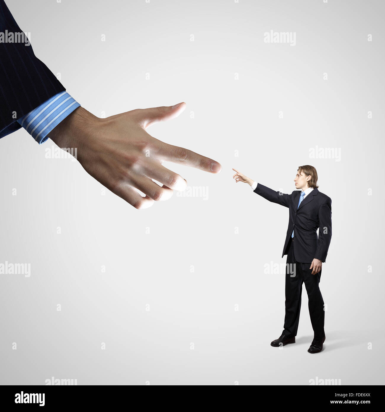 Close up of male businessman pointing at miniature of man Stock Photo ...