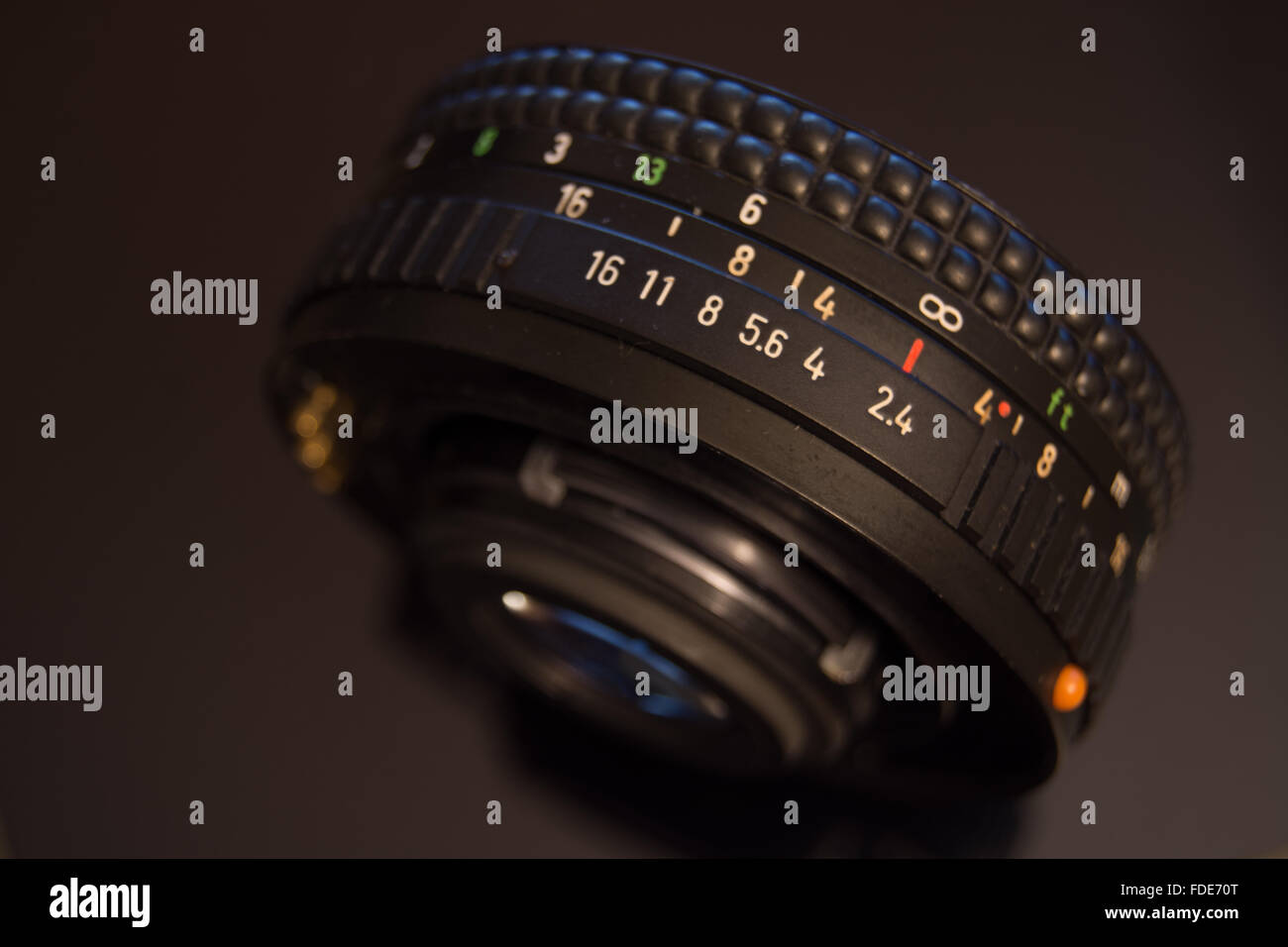 A vintage lens with focus and aperture markings shown in addition to ...