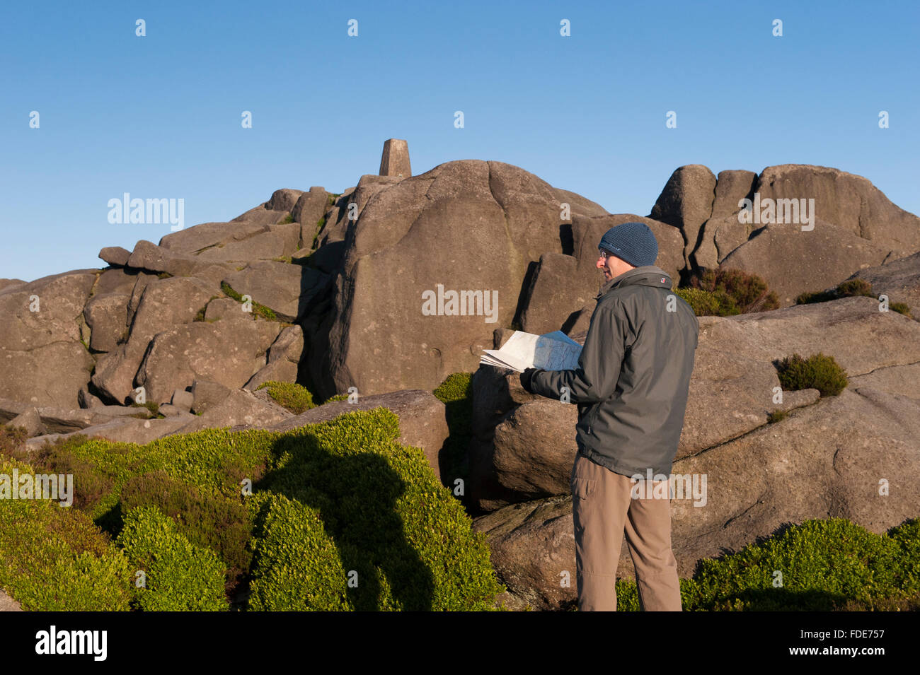 Sunshine and blue sky - man with ordnance survey map stands near the ...