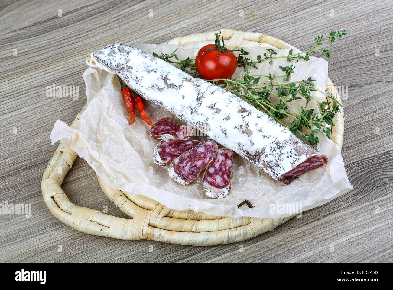 Traditional Spanish sausages- fuet with thyme leaves on the wood ...