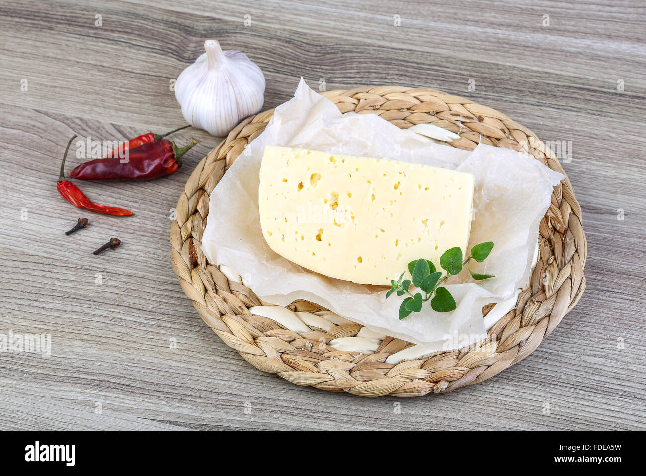 Part of round cheese on the wood background with herbs Stock Photo - Alamy
