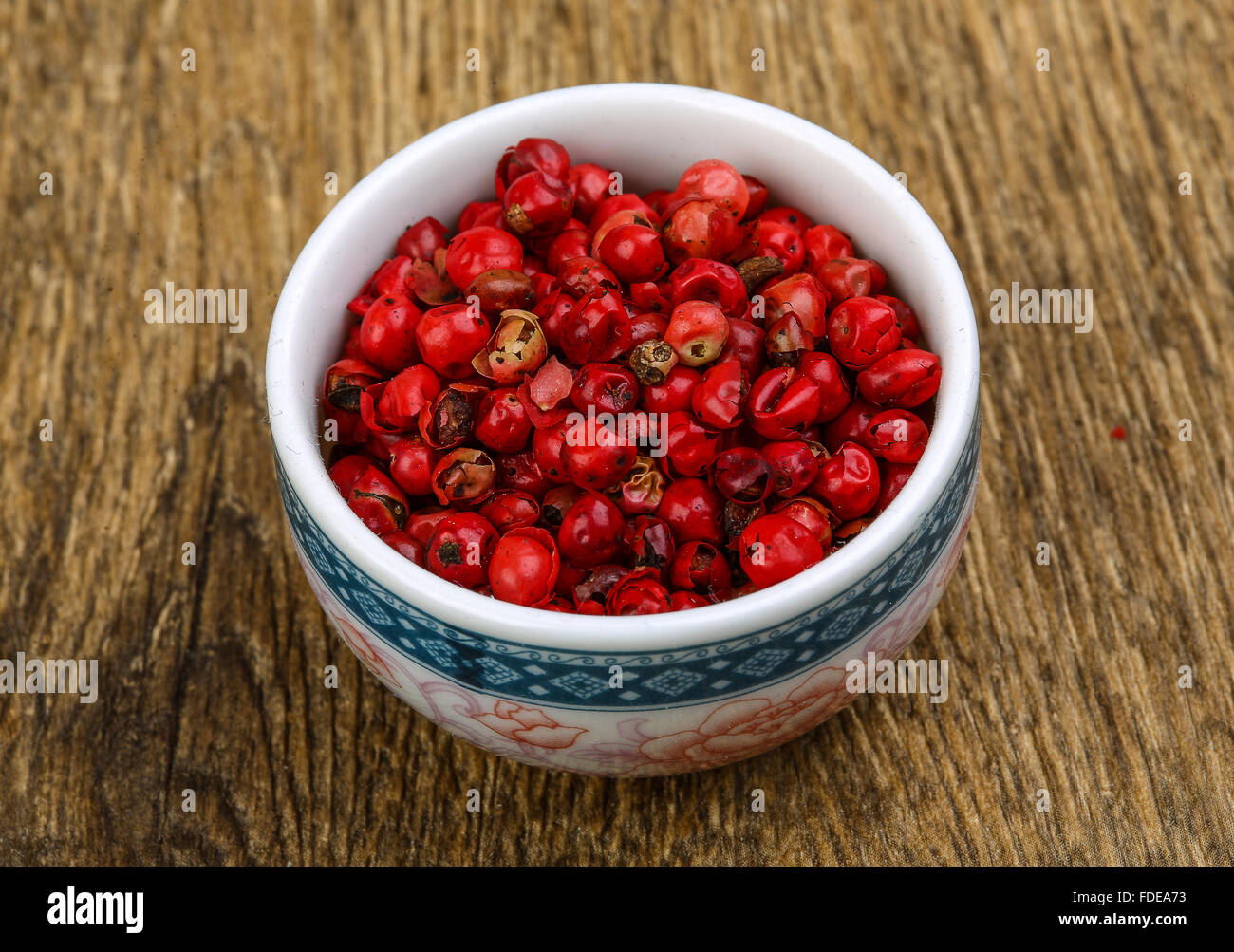Dry Rose pepper corn on the wood background Stock Photo - Alamy