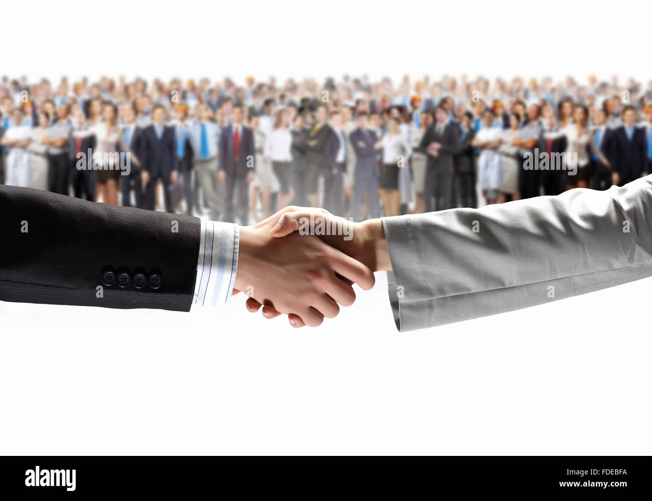 Close-up of human handshake with crowd of people at background Stock ...