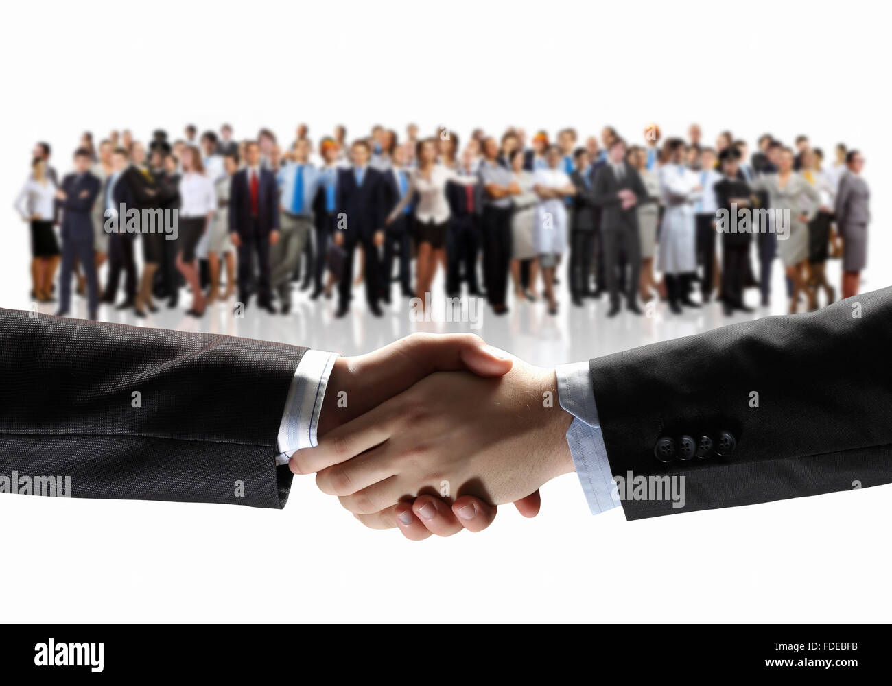 Close-up of human handshake with crowd of people at background Stock ...