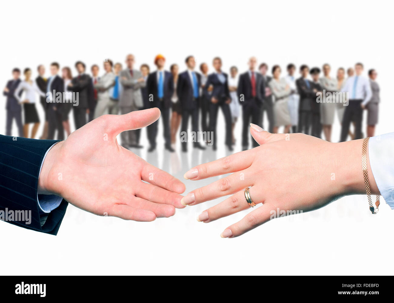 Close-up of human handshake with crowd of people at background Stock ...