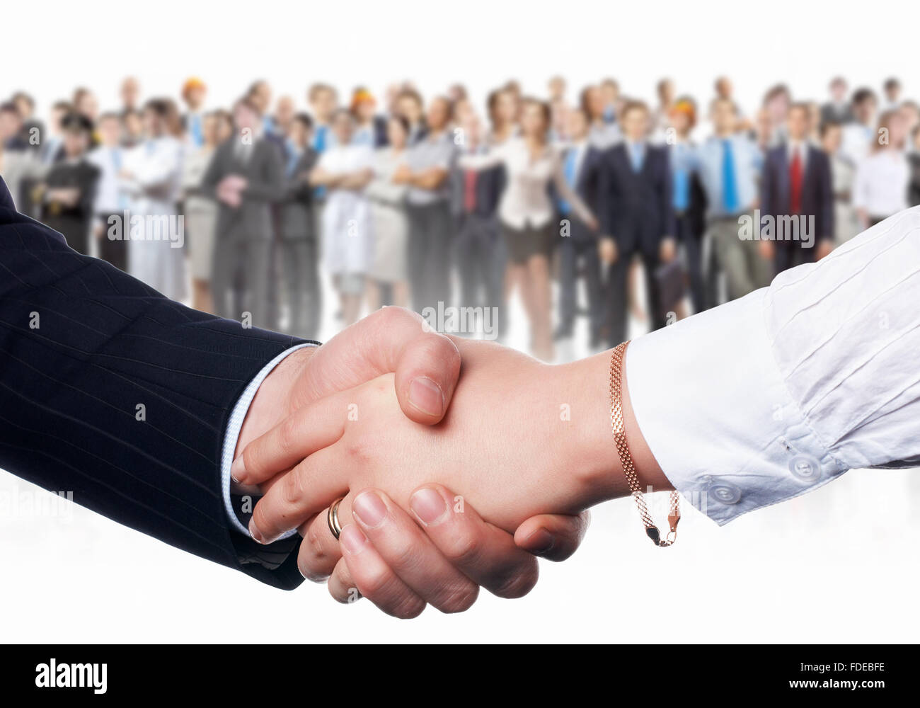 Close-up of human handshake with crowd of people at background Stock ...