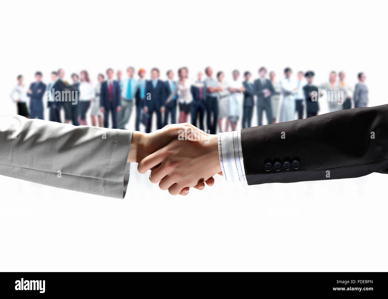 Close-up of human handshake with crowd of people at background Stock ...