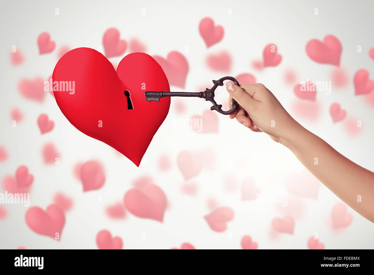 Close up of human hand with key opening heart Stock Photo - Alamy