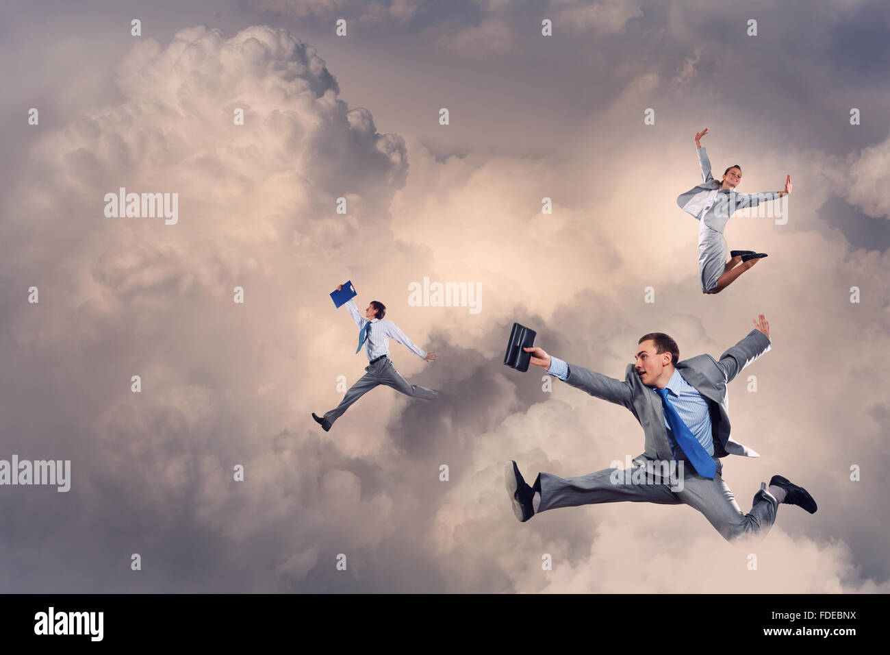 Image of businesspeople jumping high in sky Stock Photo - Alamy Image of businesspeople jumping high in sky Stock Photo - Alamy