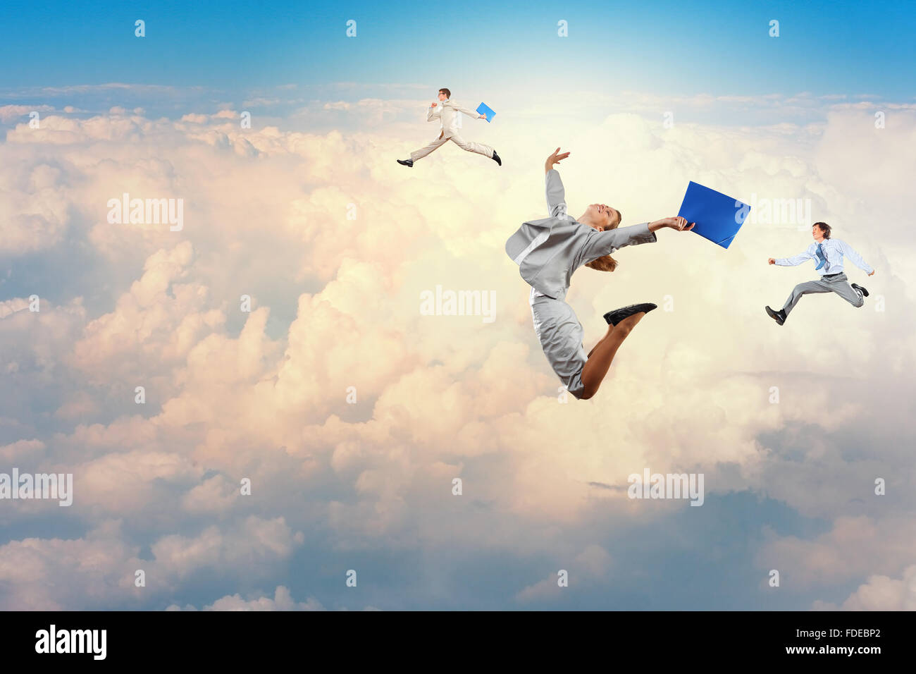 Image of businesspeople jumping high in sky Stock Photo - Alamy