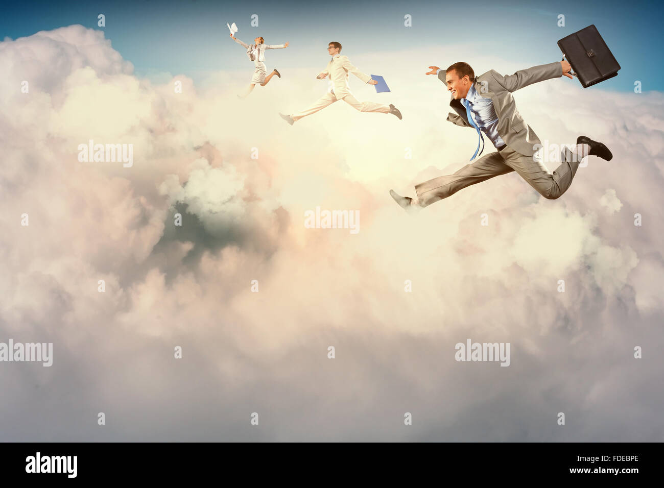 Image of businesspeople jumping high in sky Stock Photo - Alamy Image of businesspeople jumping high in sky Stock Photo - Alamy