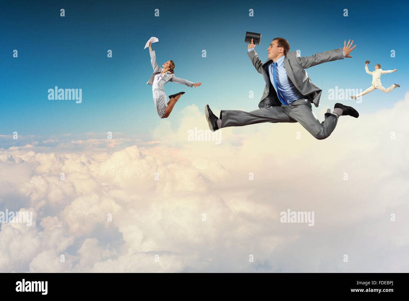 Image of businesspeople jumping high in sky Stock Photo - Alamy Image of businesspeople jumping high in sky Stock Photo - Alamy