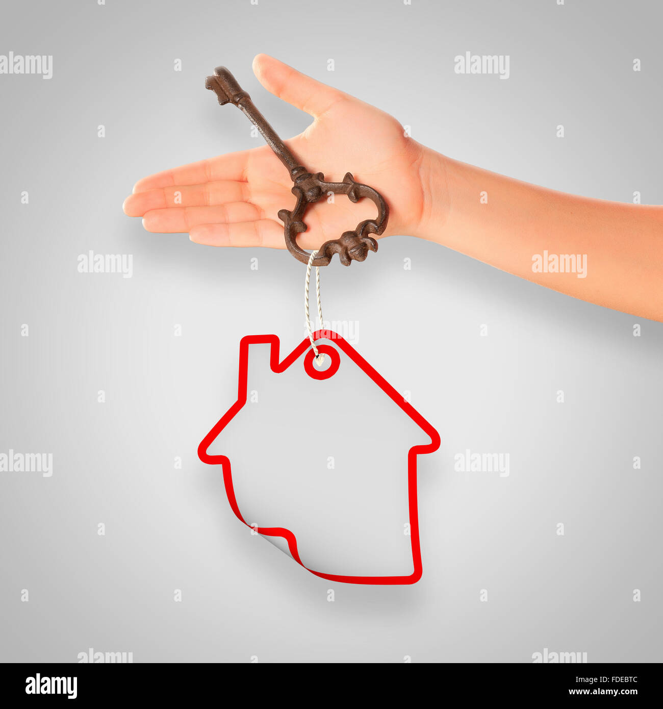 Image of key with blank label in human hand Stock Photo - Alamy